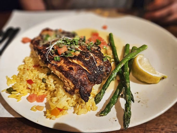 The barramundi arrives looking like it just won a culinary beauty pageant, with its crispy skin glistening under the dining room lights.