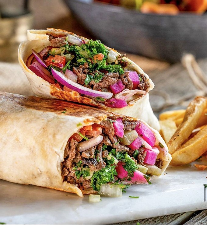 Fresh, vibrant, and packed with flavor – this shawarma wrap proves that the best things in life come rolled in pita.