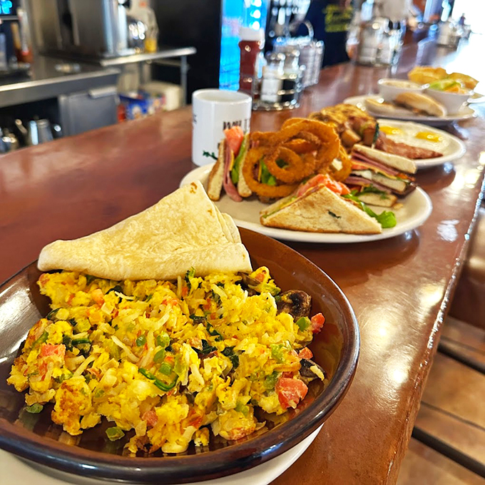 A breakfast medley that sings: Perfectly scrambled eggs dance with crispy hash browns while sandwiches stand ready in the wings. Photo credit: 5th Avenue Cafe