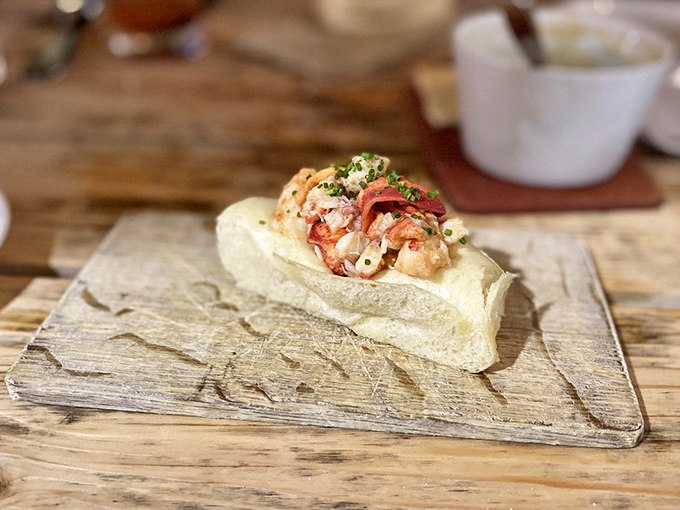 Perfectly steamed bun cradles sweet lobster meat bathed in brown butter – this isn't just lunch, it's edible poetry.