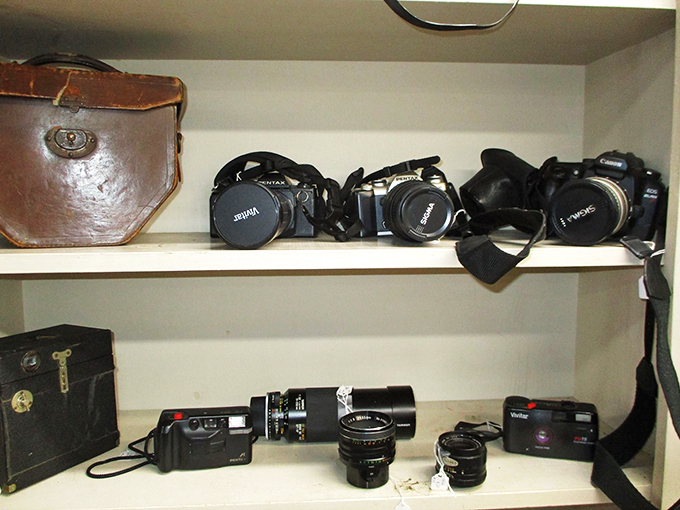 A timeline of photography history sits quietly on display, from leather cases to modern lenses.