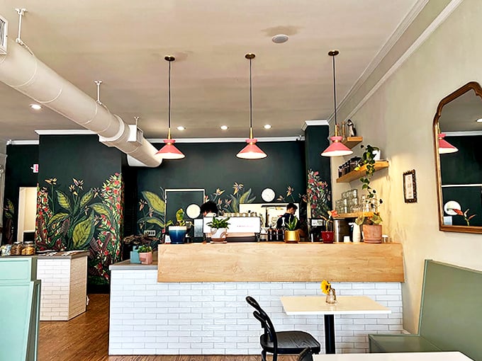 The coffee bar, backed by a tropical mural, proves someone finally figured out how to make Monday mornings something to look forward to.