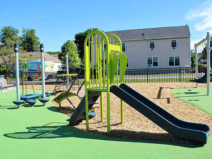 Modern fun meets small-town charm at this cheerful playground, where lime-green slides pop against the blue Maine sky.