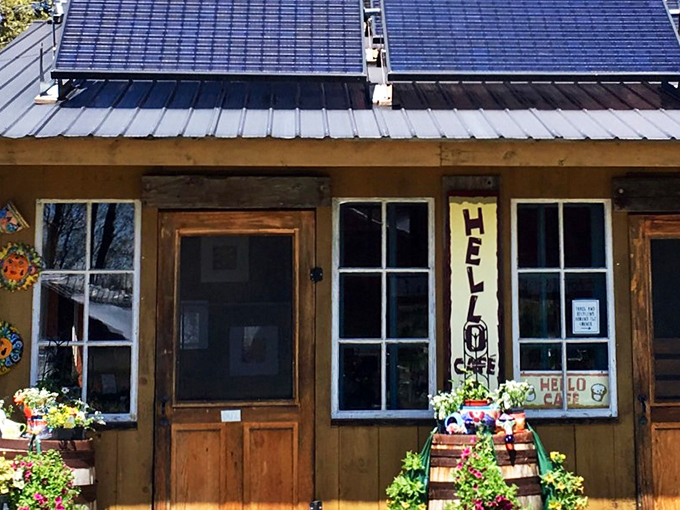 Hello Caf&eacute;'s charming facade welcomes visitors with flower-filled barrels and the promise of caffeinated bliss.