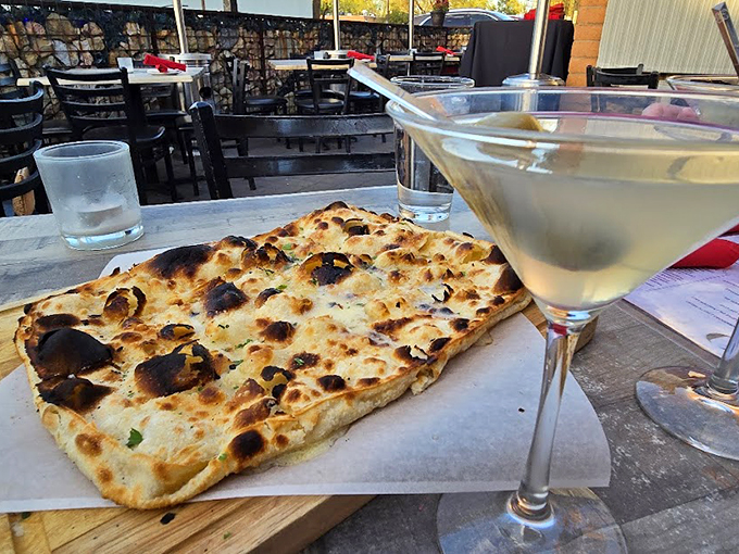 Carbs and cocktails: a match made in heaven. This flatbread and martini combo is like the Sonny and Cher of appetizers &ndash; they're even better together. Photo credit: Jon H.