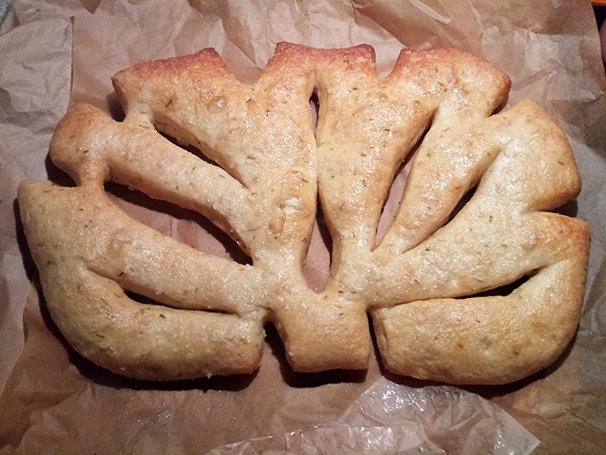 Another angle of the famous fougasse bread, showing off its perfectly golden crust and artistic leaf pattern design. Photo credit: Sleepy Snow