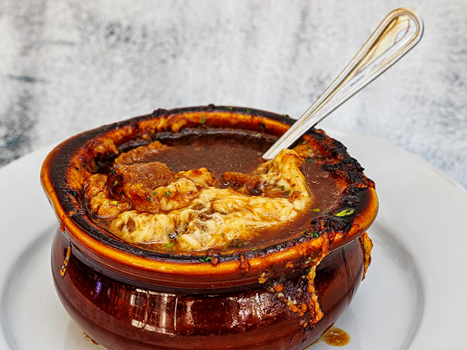 This isn't just French onion soup - it's a bubbling cauldron of joy, crowned with a golden-brown cheese cap worthy of royalty. Photo credit: Nick's Steakhouse