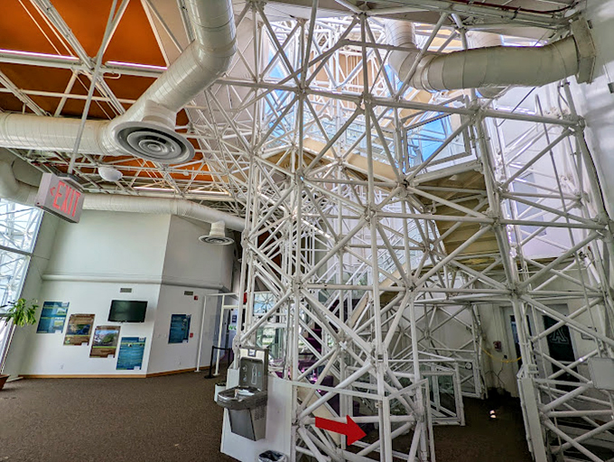 A maze of pristine white support structures creates an industrial ballet, showing the complex engineering keeping this artificial world turning.