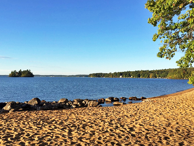 Rocky sentinels guard the shoreline while gentle waves create nature's own meditation soundtrack on this peaceful beach.