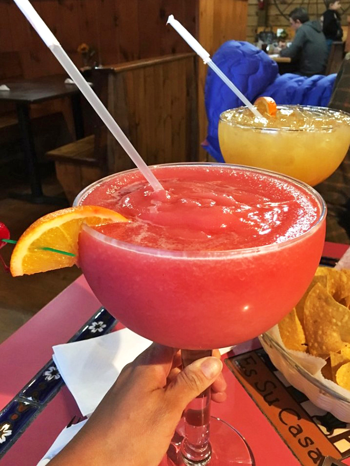 This rosy giant isn't just a margarita - it's a vacation in a glass, complete with a fresh orange slice for that extra burst of joy.