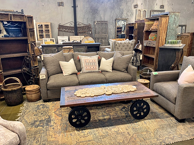 Rustic chic meets cozy comfort in this living room setup. It's like your grandma's attic and a hip loft had a beautiful furniture baby. Photo credit: Potato Barn Unique Home Furnishings