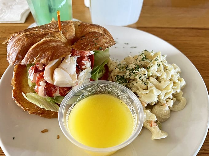 The legendary lobster croissant arrives like royalty, accompanied by creamy pasta salad and drawn butter fit for Neptune himself. Photo credit: Deb B.