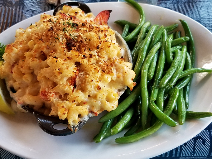 A side of crisp green beans adds a fresh crunch to the decadent lobster mac and cheese masterpiece. Photo credit: garrett bobo