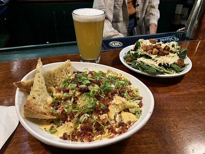 A symphony of cheese, pasta, and fresh lobster, garnished with scallions - comfort food that's dressed for a night out.