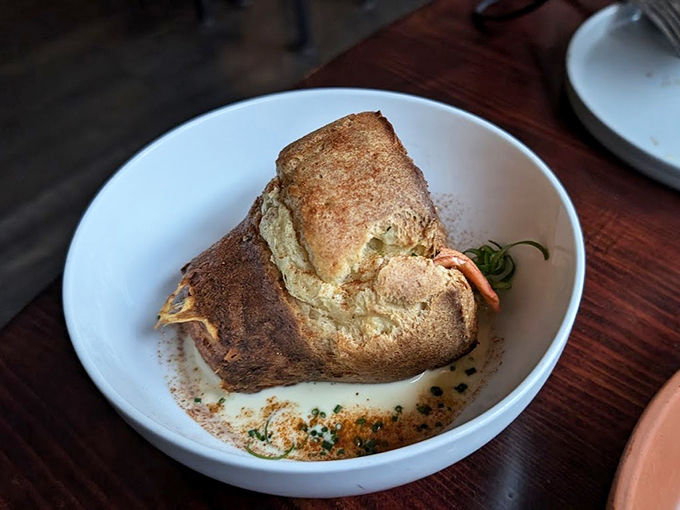 The legendary lobster popover arrives like a golden crown, ready to bestow delicious memories upon lucky diners.