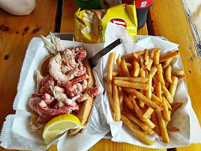 This isn't just a lobster roll - it's a celebration of Maine's finest, bursting with sweet meat and served with golden fries. Photo credit: Steve Boggs