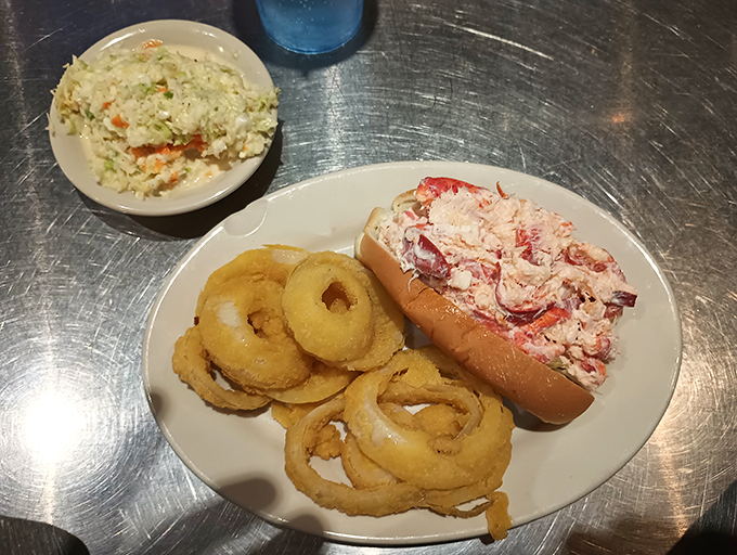 The holy trinity of Maine cuisine: lobster roll, onion rings, and coleslaw. It's like a hug for your stomach, only tastier.