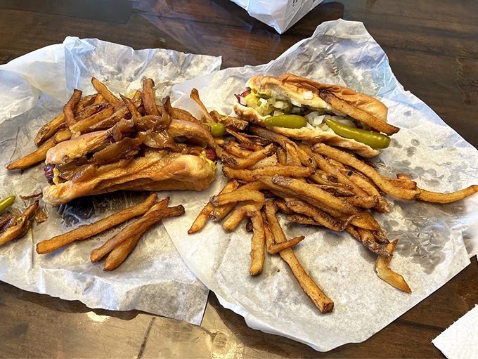 A symphony of flavors: grilled onions cascade over a perfectly charred Polish sausage, while fresh-cut fries stand ready for duty.