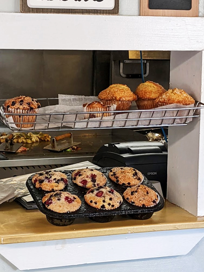 Fresh-baked muffins and pastries stand at attention like delicious soldiers, ready for their morning mission of bringing joy.