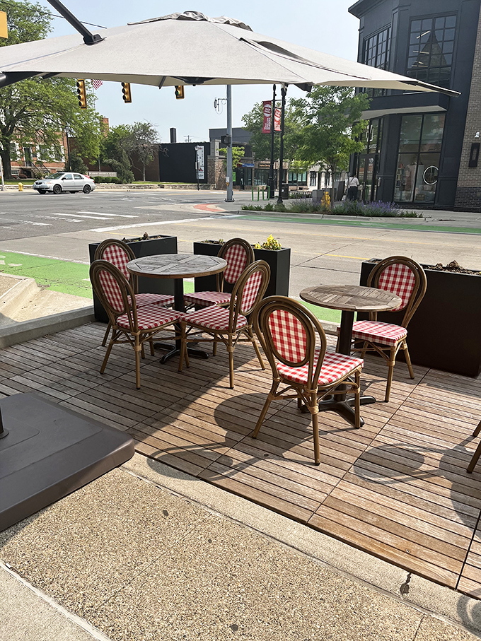 Alfresco dining with a side of people-watching. These red gingham chairs are like picnic blankets that grew up and got fancy jobs in the city.