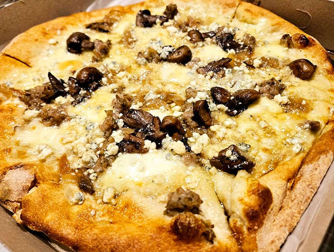 This isn't just any mushroom pizza &ndash; it's a symphony of roasted fungi and melted cheese on a perfectly charred crust. Photo credit: Jonathan Schutte