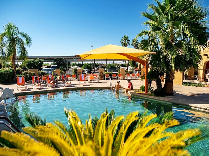 Splash into serenity! This pool area is an oasis of relaxation, where palm trees and lounge chairs invite you to forget about the world outside. Photo credit: Tucson / Lazydays KOA Resort