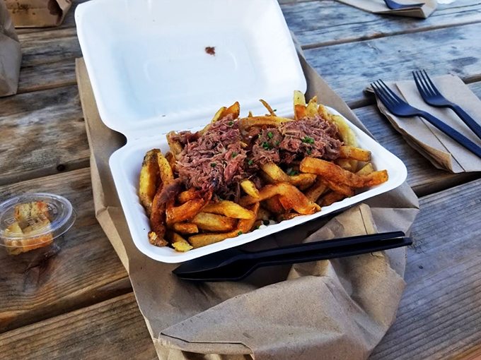 Duck confit crowns these crispy fries like royalty, while cheese curds and gravy create a symphony of savory satisfaction.