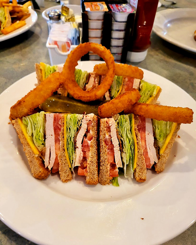 This club sandwich stands taller than most Chicago skyscrapers, complete with a crown of onion rings fit for royalty.