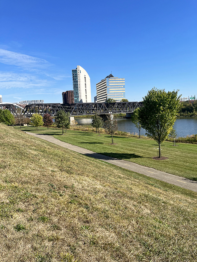 Beyond the slingshot lies Columbus in all its glory. It's like the city is saying, "Sure, we've got skyscrapers, but have you seen our oversized toys?"