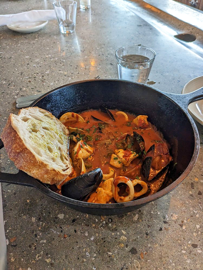 This isn't just seafood stew &ndash; it's a warm hug from the Atlantic, served with crusty bread for soaking up every drop. Photo credit: ryan j.