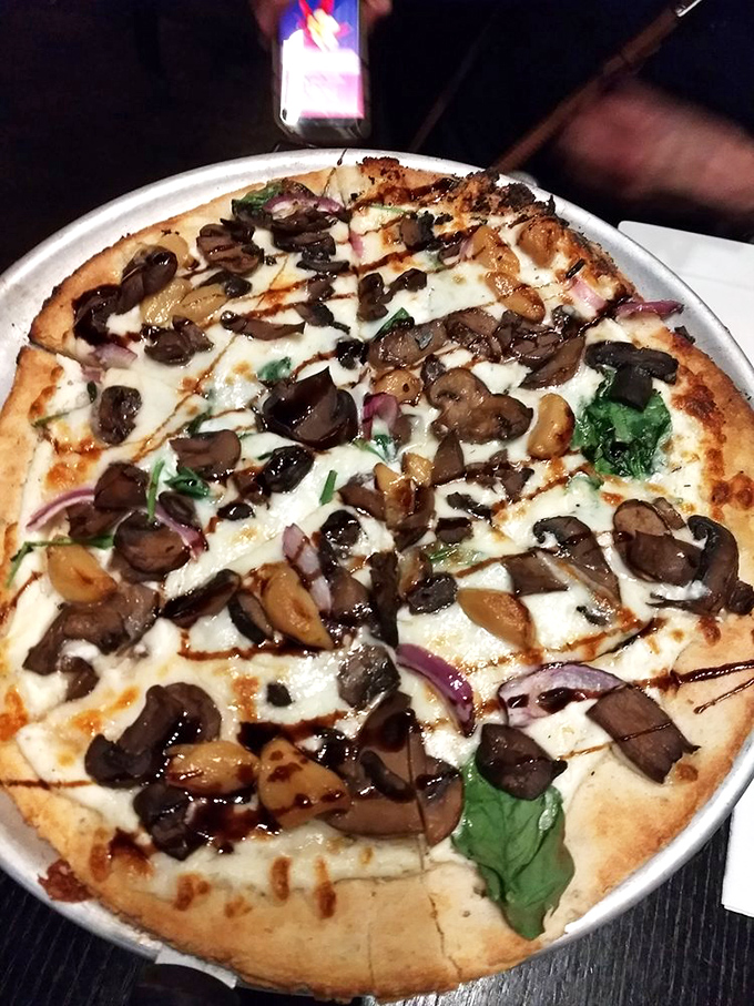 This isn't just any mushroom pizza &ndash; it's a symphony of perfectly roasted fungi, melted cheese, and fresh herbs on a blistered crust.