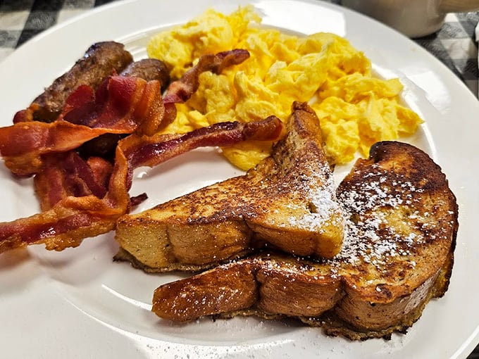 The holy trinity of breakfast: crispy bacon, fluffy eggs, and golden toast. It's like a morning hug on a plate!