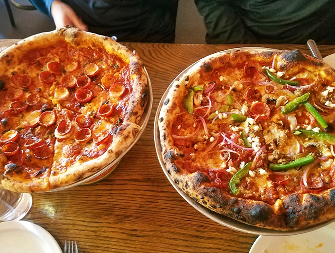 Behold, the dynamic duo of dough! One's playing it cool with classic pepperoni, while the other's living on the edge with a veggie medley. Choose your fighter!