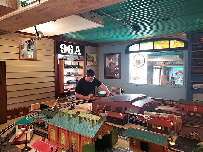 Caught in the act of pure joy! This visitor's face says it all - who knew playing conductor could be more fun than being an actual adult?