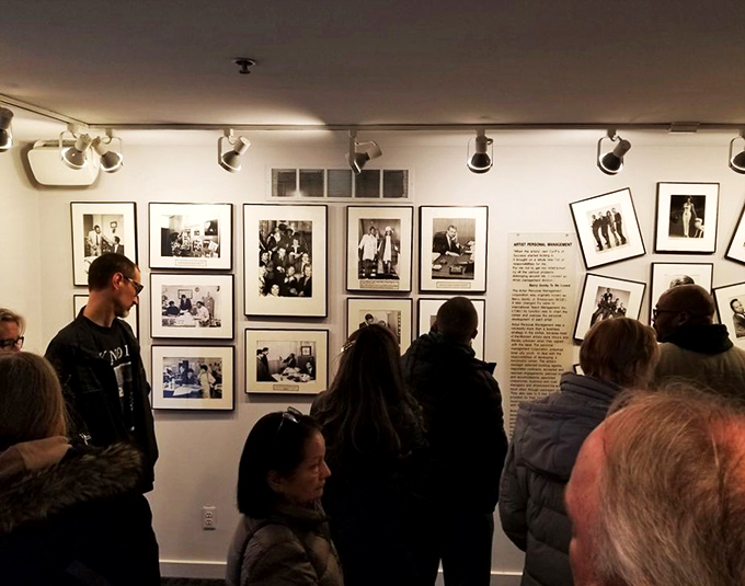 Music lovers gather around historic photographs, each image a window into Motown's golden age of harmony and hope.