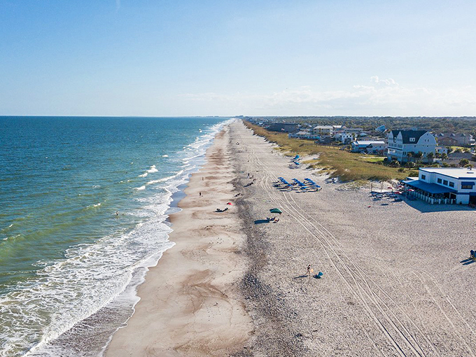 Miles of sugary sand stretch into forever, while coastal homes stand sentinel. Nature's own infinity pool meets architectural elegance.