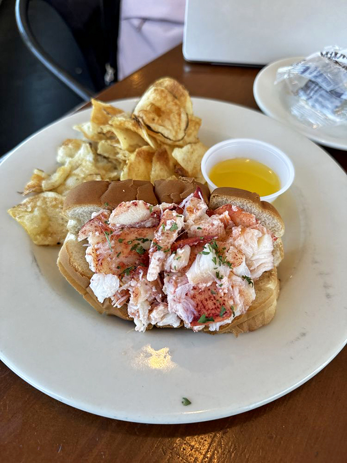 Lobster roll perfection: where the ocean meets the plate. Paired with crispy chips, it's a match made in seafood heaven.