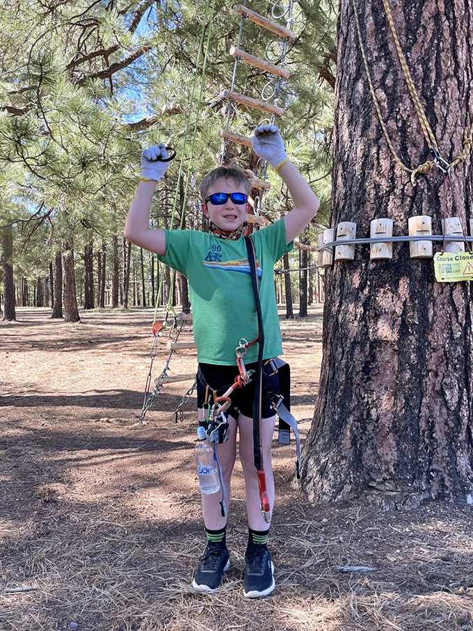 Victory pose achieved! This young explorer has mastered the course and the art of the triumphant stance. Future American Ninja Warrior in training?