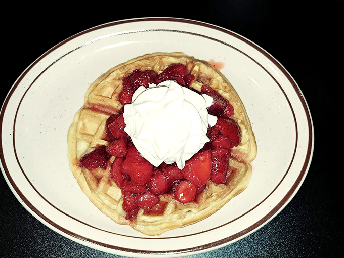 Waffles that could make Leslie Knope weep with joy, crowned with a berry bonanza and a cloud of whipped cream.
