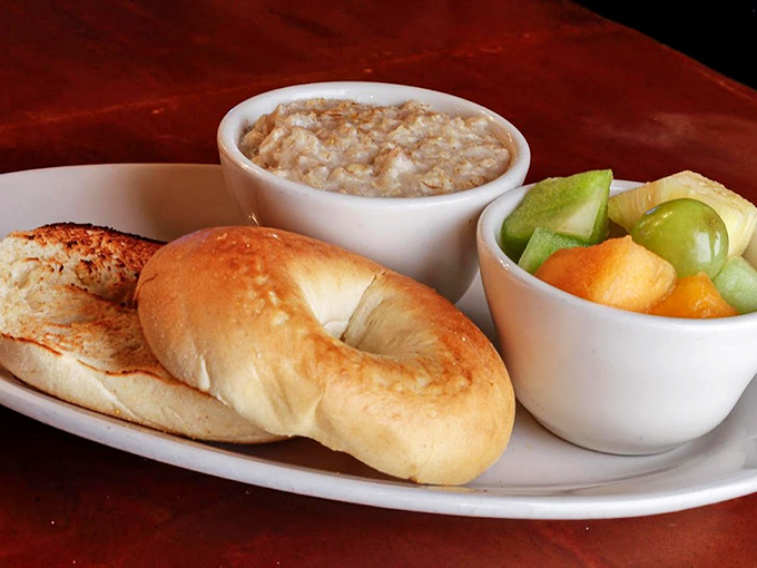 Simple pleasures done right: A fresh bagel, creamy oatmeal, and seasonal fruit create a breakfast trio worth waking up for. Photo credit: 5th Avenue Cafe
