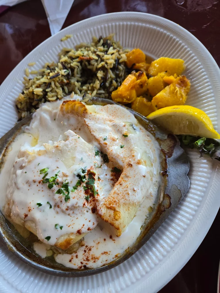 Like a cozy blanket for your taste buds, this baked stuffed haddock comes dressed in its Sunday best with wild rice. Photo credit: John Dubro