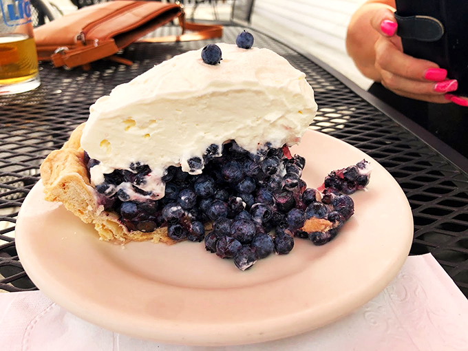 Maine's wild blueberries huddle together under a cloud of whipped cream, creating a dessert that's basically summer in pie form.