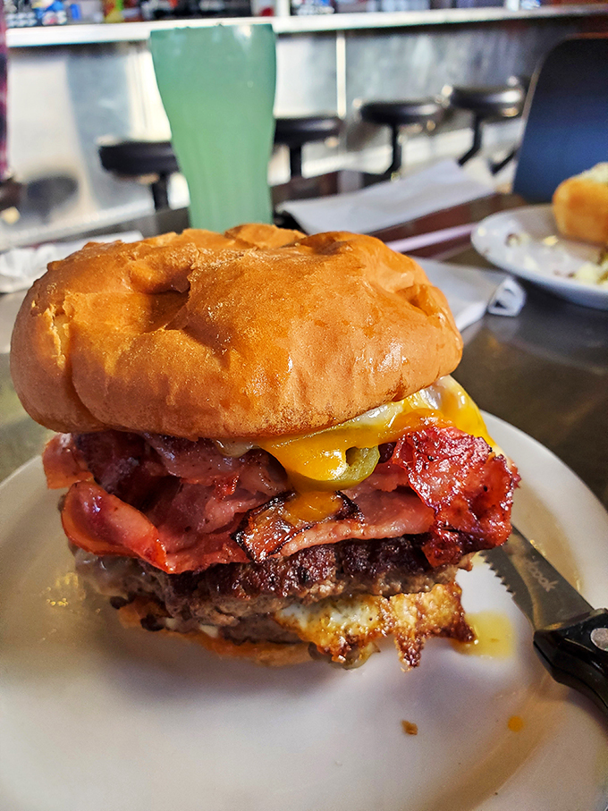 Holy cow! This burger's stacked higher than my to-read pile. It's a towering testament to the art of indulgence.