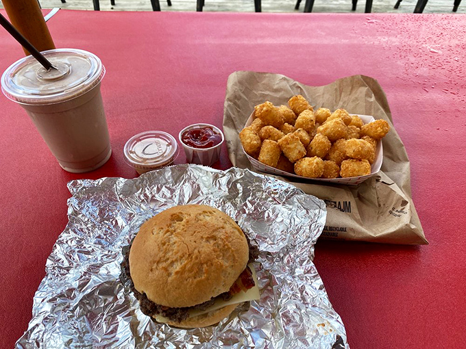 A perfect trifecta: golden-brown burger, creamy milkshake, and those legendary tater tots that deserve their own fan club.
