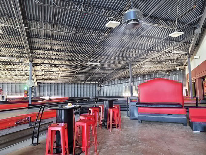 Red Adirondack chairs create a scene that's part race day, part unwind day. It's the mullet of spaces - business in front, party in the back!