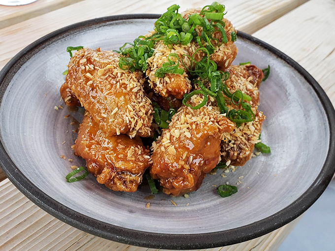These aren't your average wings &ndash; they're dressed to impress with a golden glaze and a shower of fresh herbs. Photo credit: Josh Koelker
