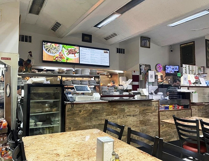Behind this bustling counter, the kitchen symphony plays out daily, with digital menus keeping tempo above the organized chaos.
