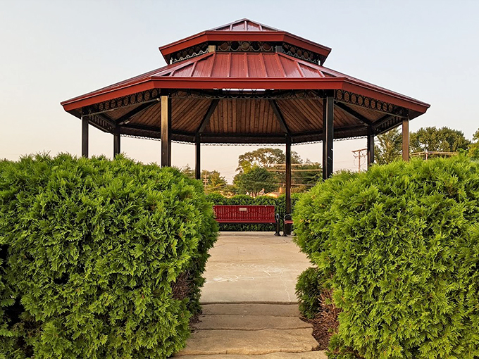 This elegant gazebo, framed by evergreens, stands ready for everything from summer concerts to impromptu picnic shelter duty.