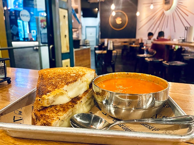 Golden-brown bread hugs perfectly melted cheese while tomato soup stands by, ready for its dunking destiny. Photo credit: Christine A