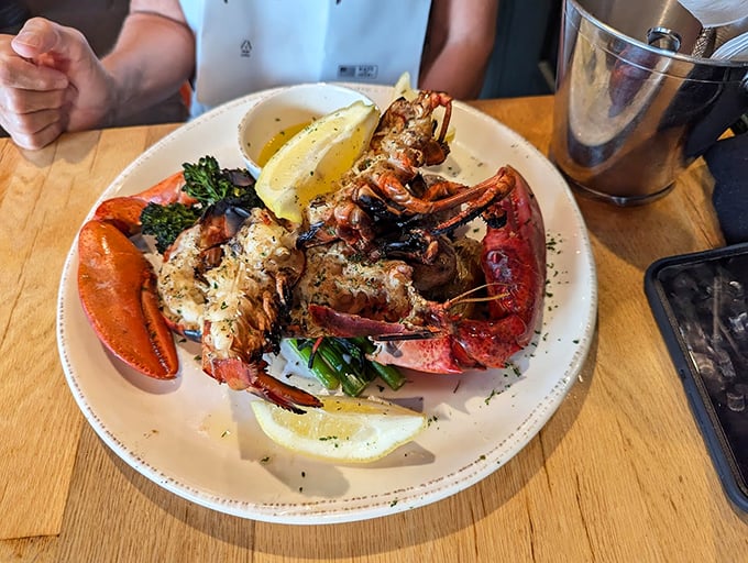 Char-kissed lobster meat glistens with drawn butter, while fresh broccoli adds a pop of color to this wood-fired masterpiece. Photo credit: Josh Davis
